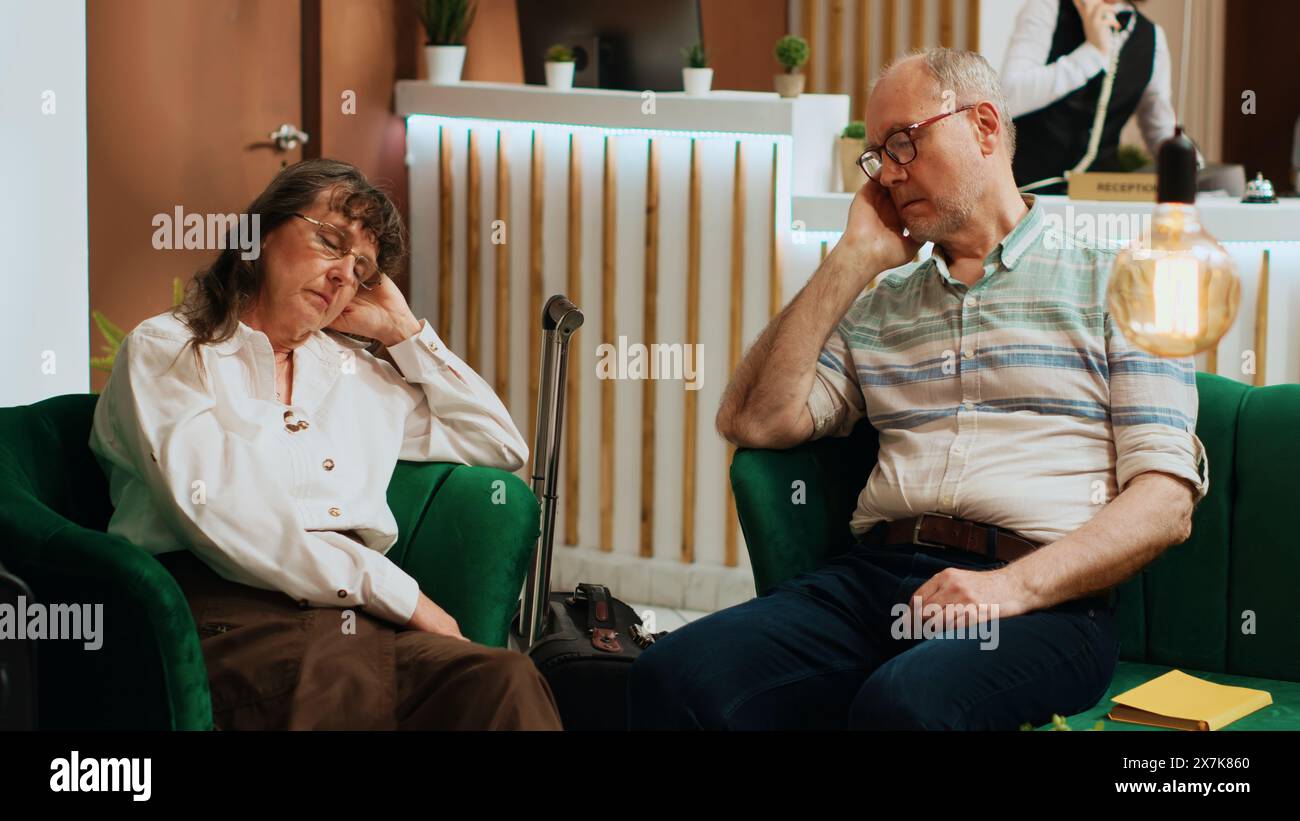 Sleepy old people taking nap on sofa at hotel, feeling tired because of ...