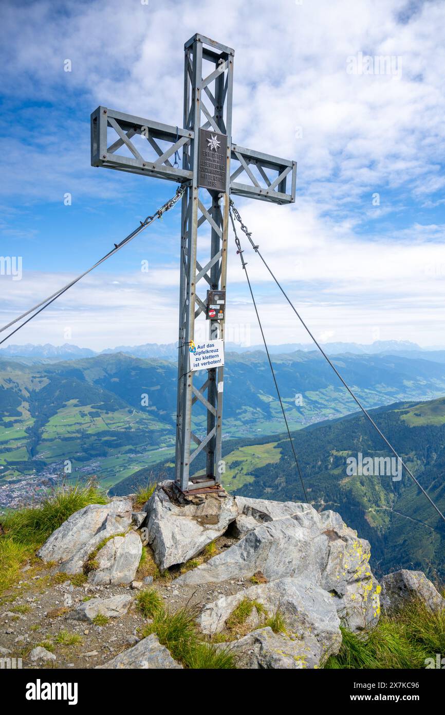 A cross marks the summit of Pihapper Mountain against a backdrop of ...