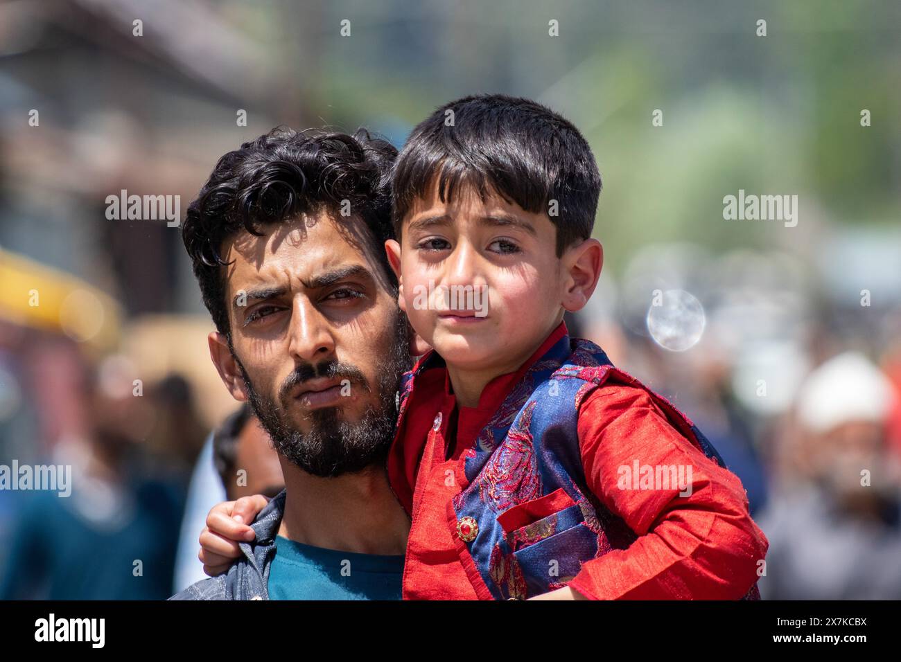Shopian, India. 19th May, 2024. A relatives carrying the son of the ...