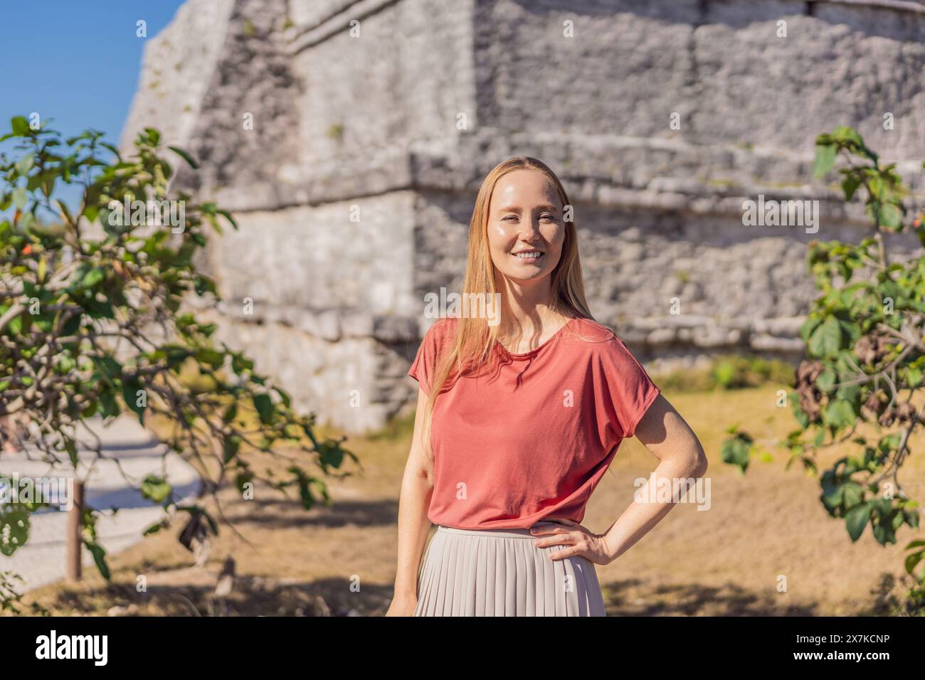 Woman tourist enjoying the view Pre-Columbian Mayan walled city of ...