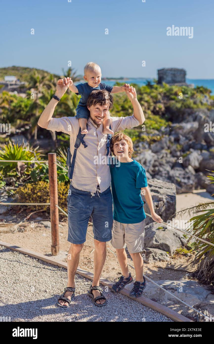 Father and two sons tourists enjoying the view Pre-Columbian Mayan ...