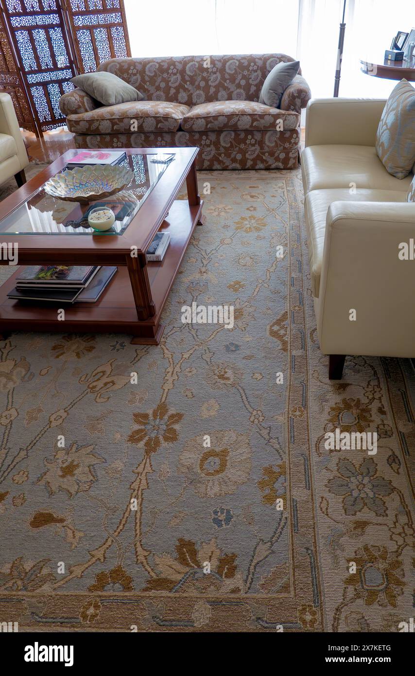 Living room carpet with sofa and coffee table and books Stock Photo - Alamy