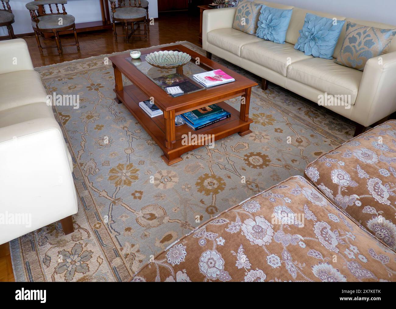 Living room carpet with sofa and coffee table and books Stock Photo - Alamy