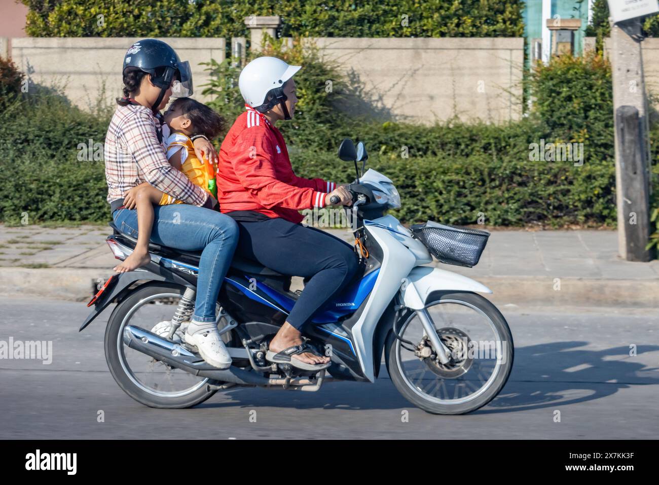 BANGKOK, THAILAND, MAR 24 2024, Women ride a motorcycle with a small ...
