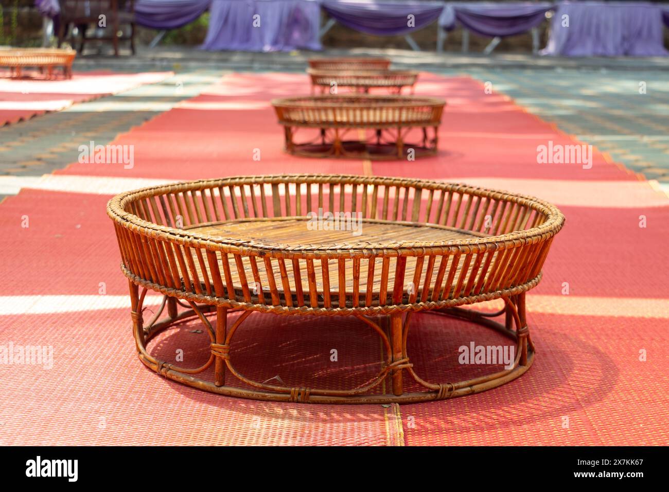 A row of empty baskets on a mat in an outdoor restaurant - Khan Toke ...