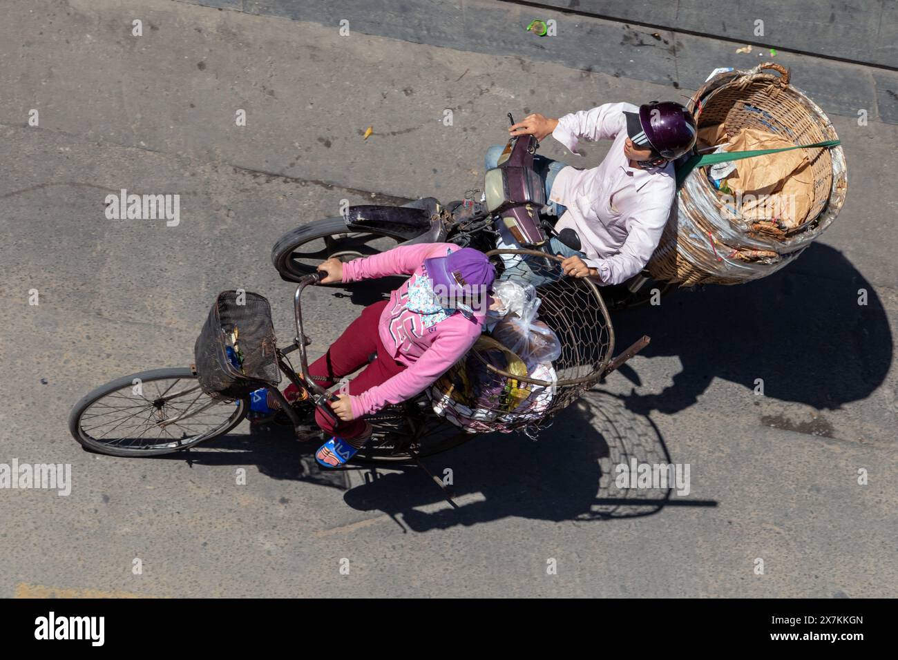 SAIGON, VIETNAM, DEC 17 2017, A man drives a motorcycle loaded with ...