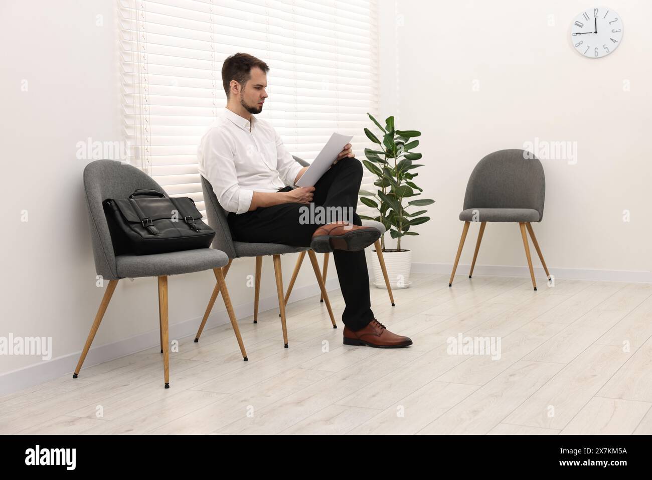 Man with sheet of paper waiting for job interview indoors Stock Photo ...