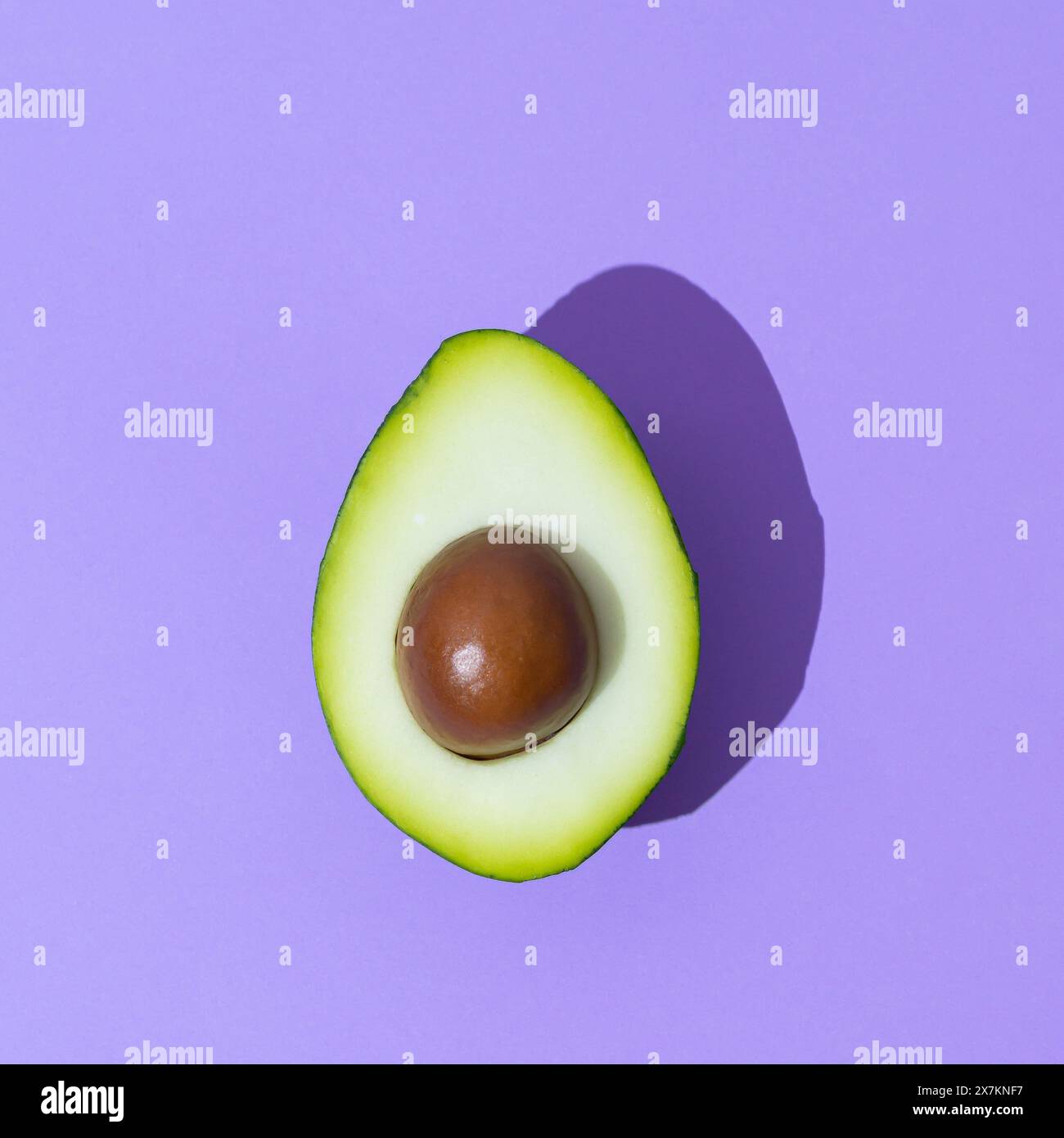 Fresh avocado on purple background. Minimal tropical organic fruit ...