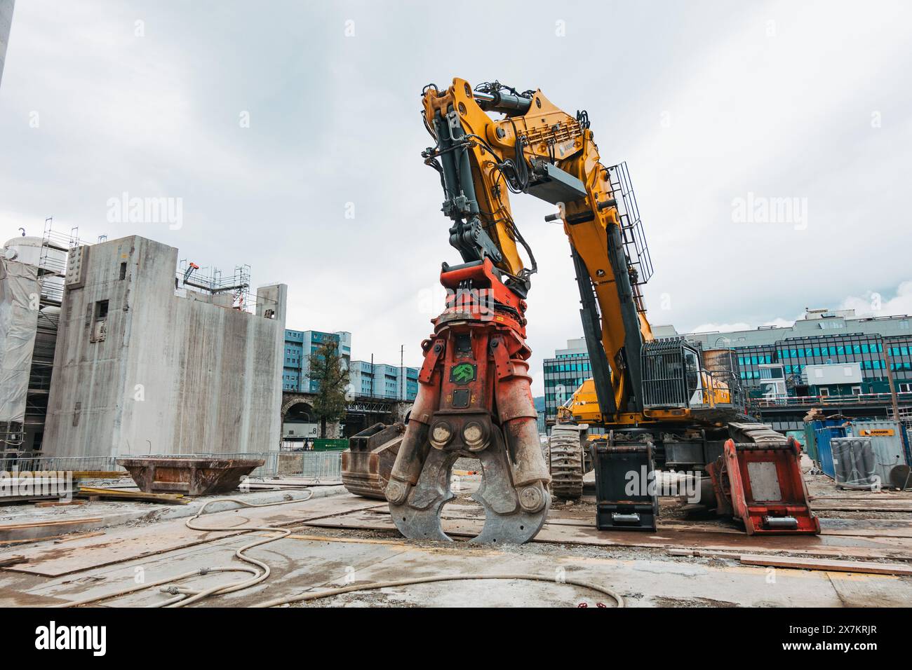 an excavator fitted with a hydraulic shear attachment, for use on a ...