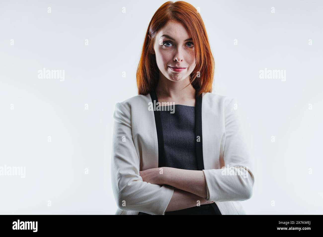 Professional-looking female with bright red hair and a playful smirk ...