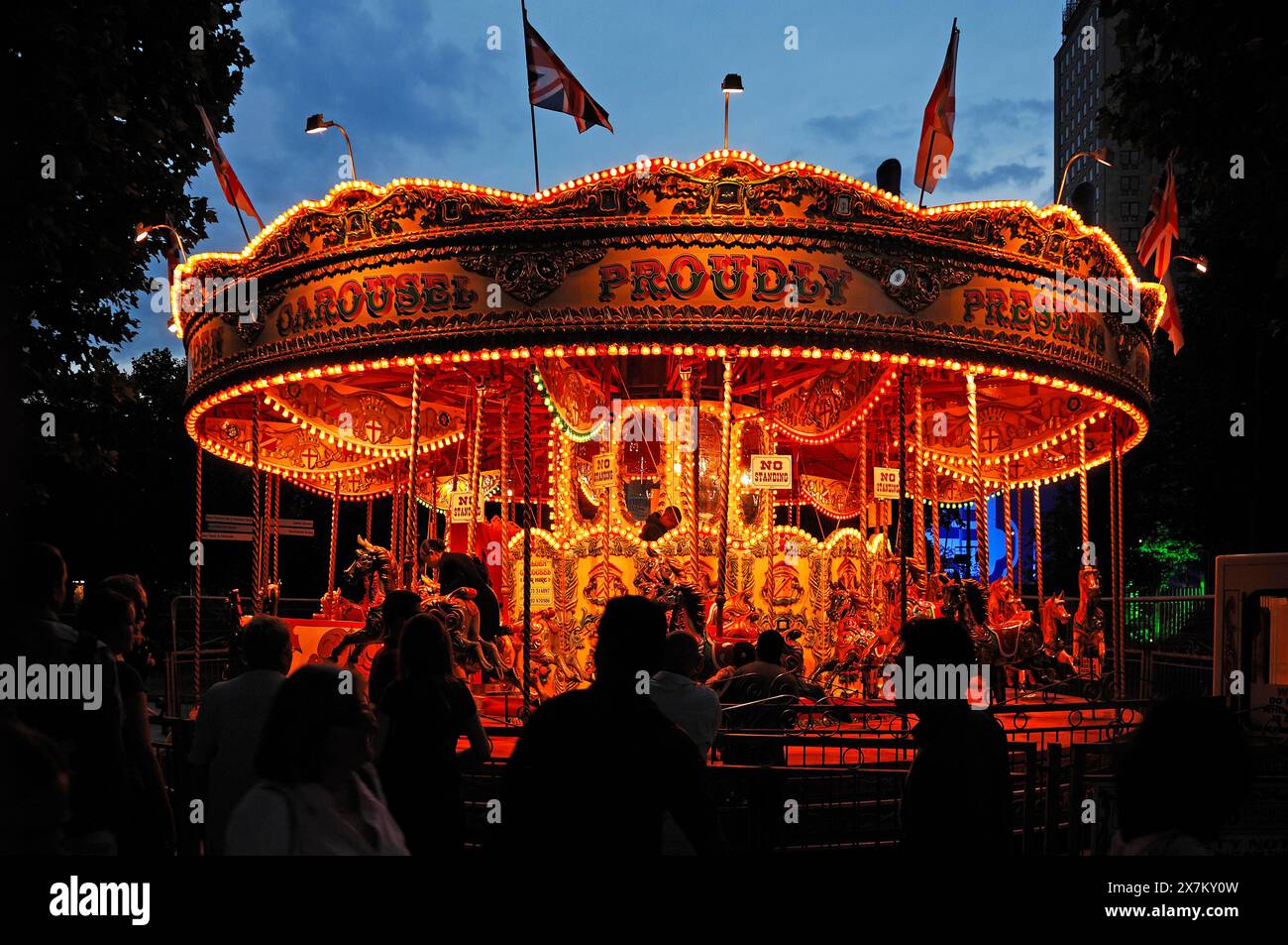 Children's carousel with evening lighting at Queens Walk on the Thames ...