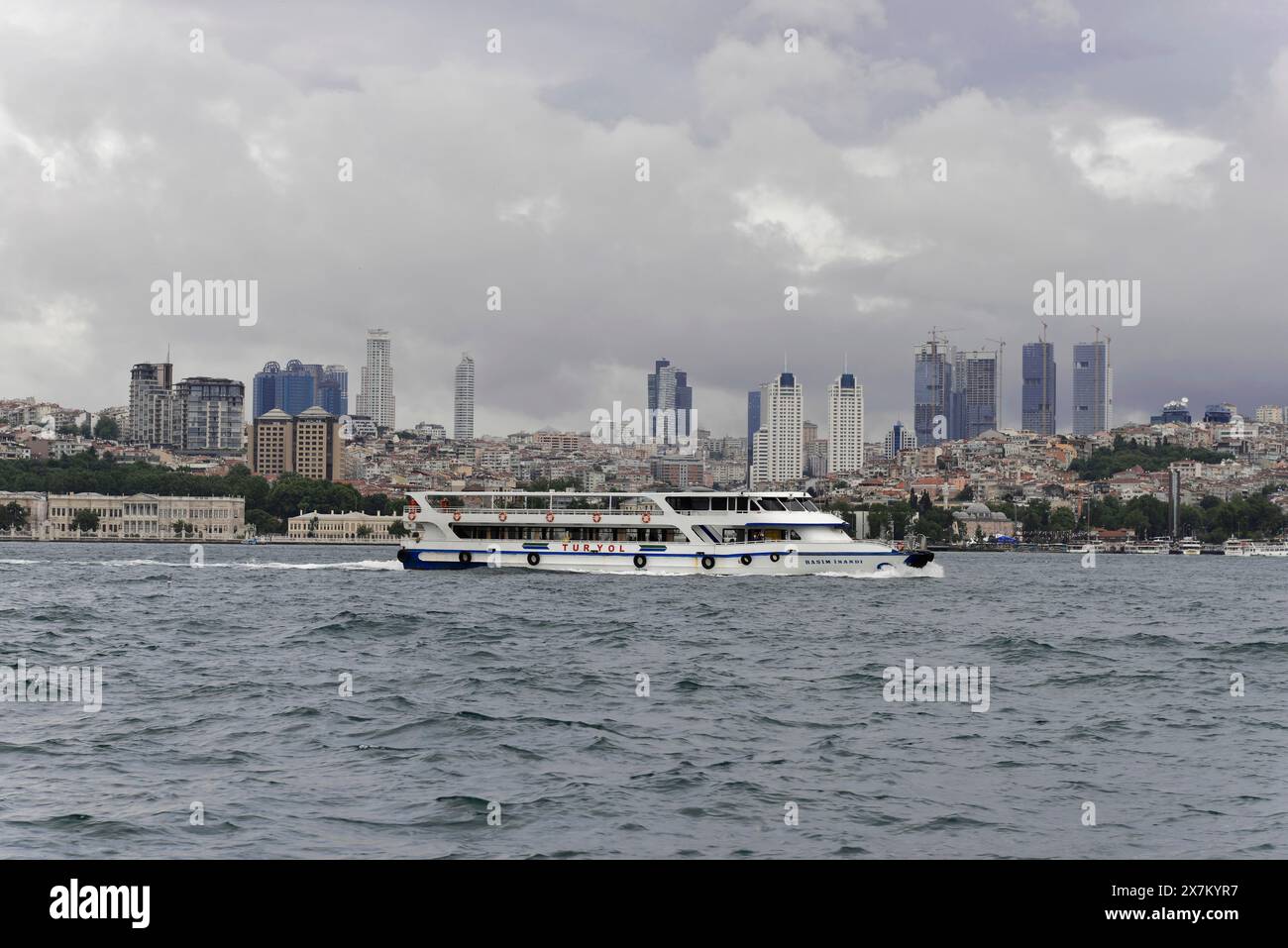 Ship sailing on the water with a view of Istanbul's modern city skyline ...