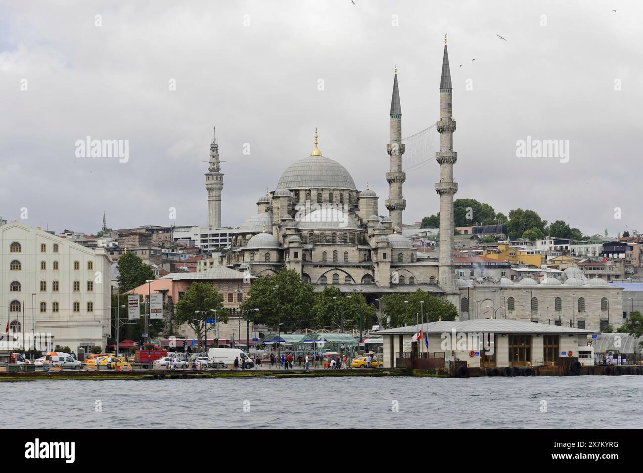 A mosque with two minarets on the coast of Istanbul, grey sky in the ...