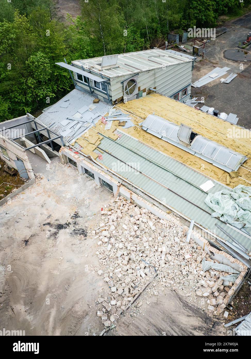 A construction site with a partially demolished building and demolished ...