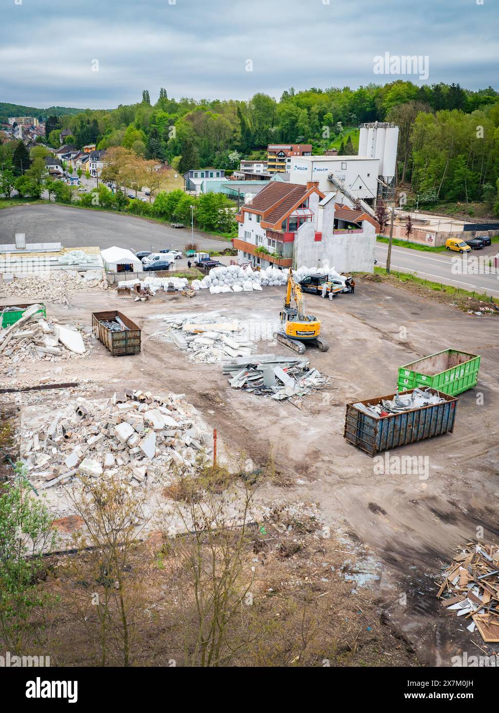 A construction site with demolished material and containers, machines ...