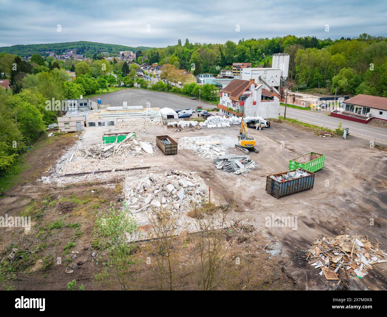 A construction site with demolished material, containers and machines ...