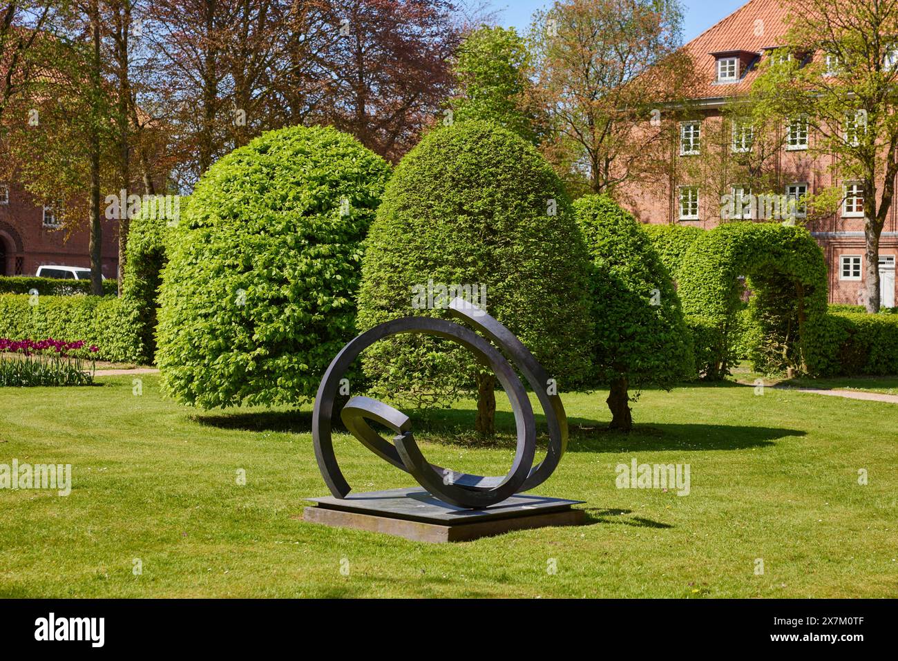 Art object and european hornbeams (Carpinus betulus) with topiary in ...