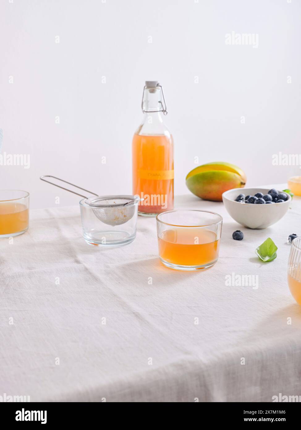 A bottle of homemade fermented kombucha drink with fruit flavour on ...