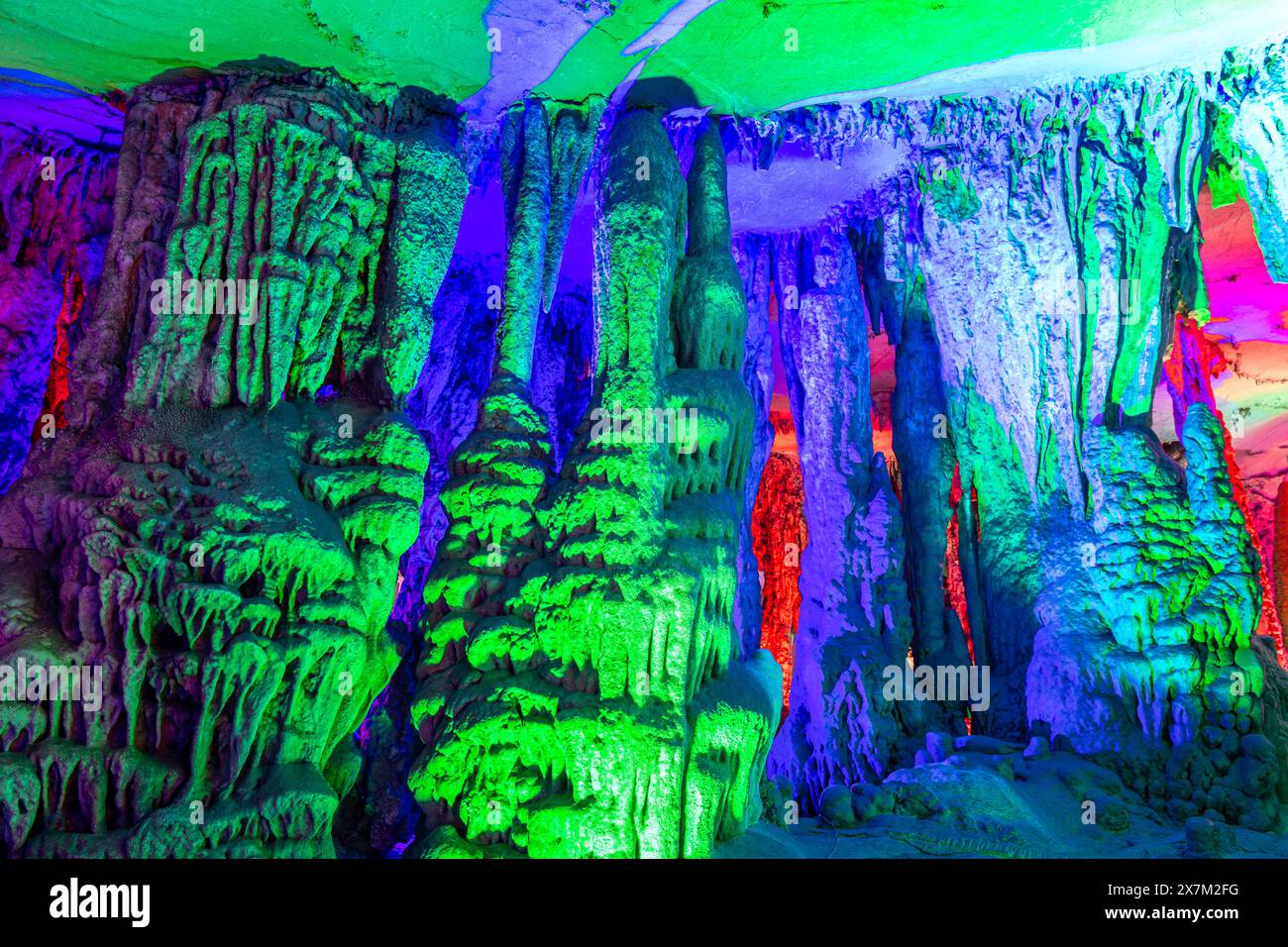 Inside the cave. Stalactites, stalagmites, colored light. Beautiful ...