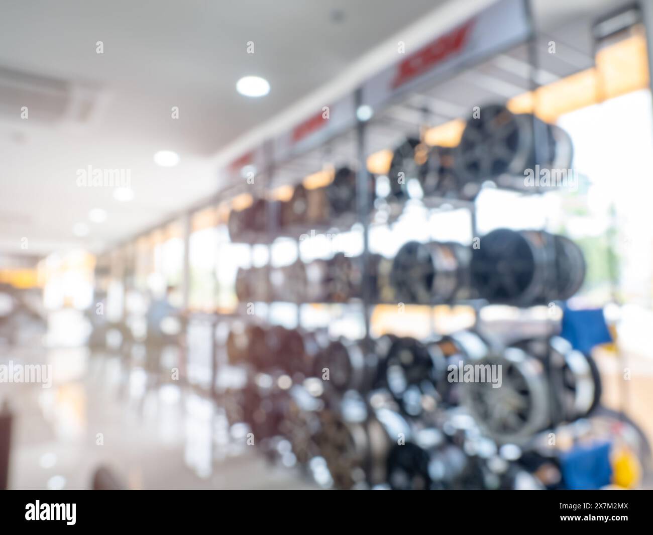 Blurred focus scene of tyre store decoration with many steel alloy ...