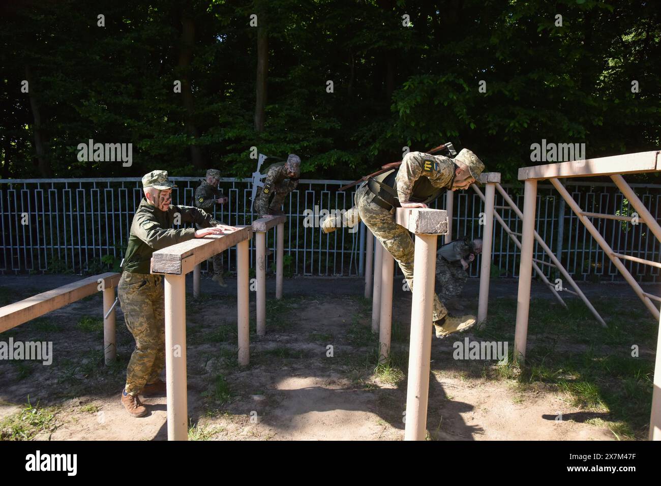 Cadets overcome an obstacle course during the first competition in ...