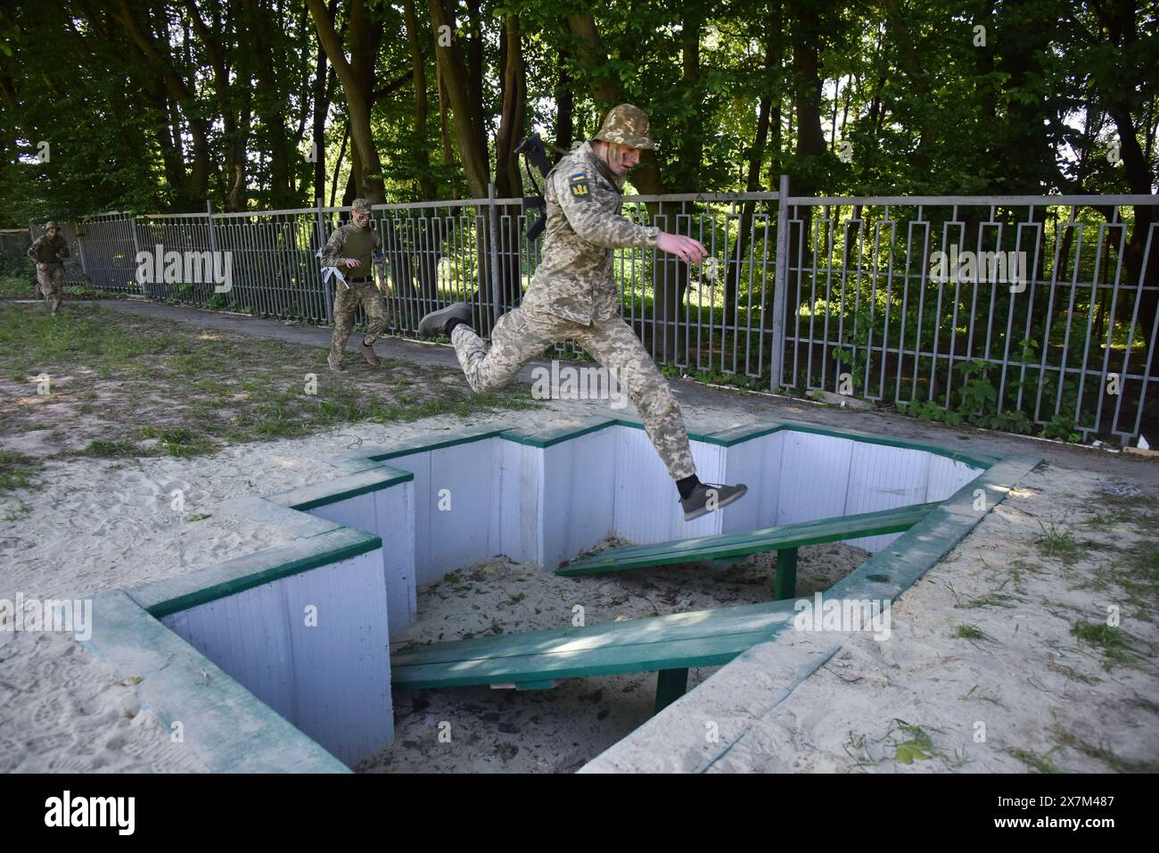 Cadets overcome an obstacle course during the first competition in ...