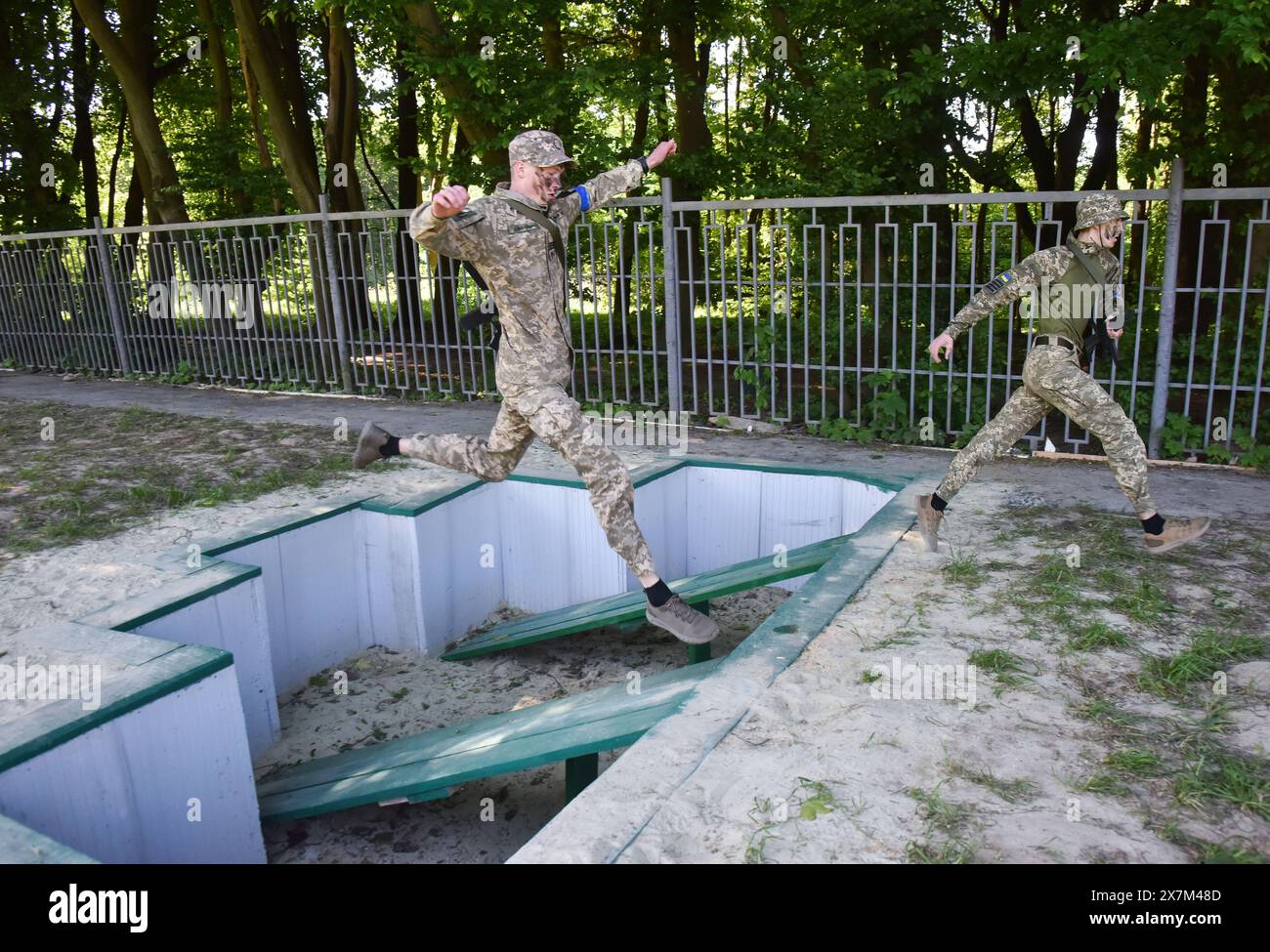 Cadets overcome an obstacle course during the first competition in ...