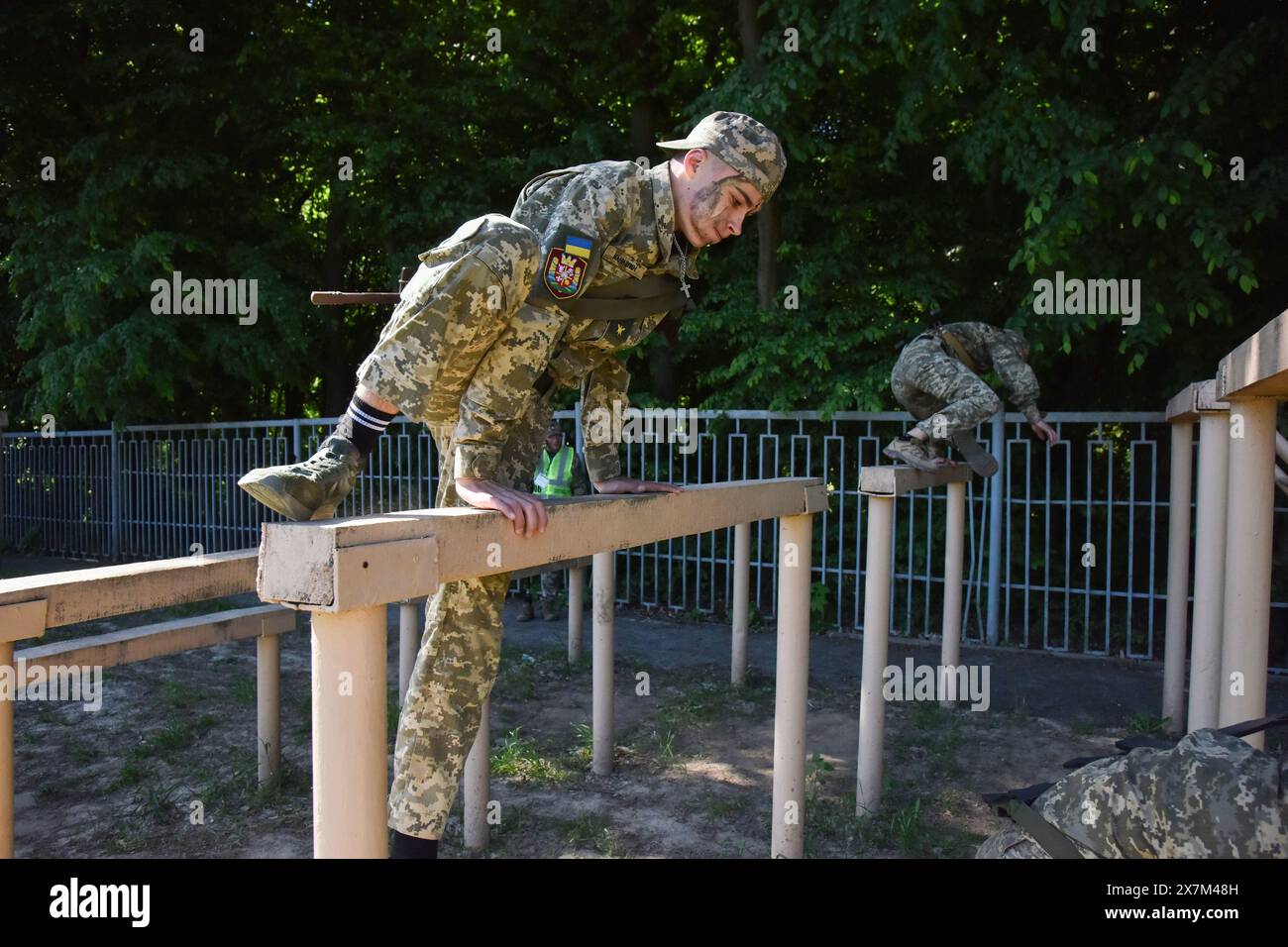 A cadet overcomes an obstacle course during the first competitions in ...