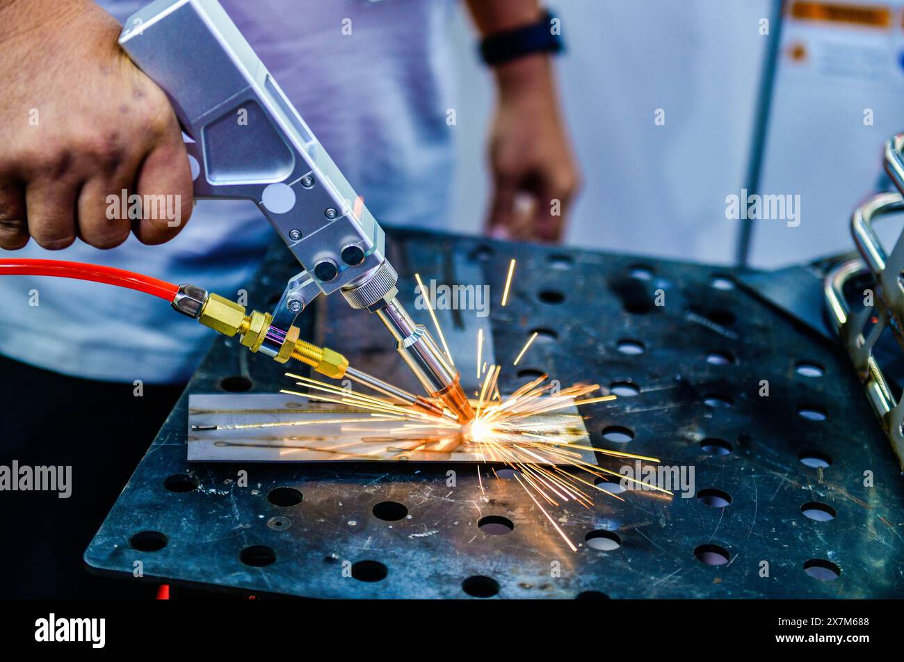 Industry worker welding iron pieces work at the factory Stock Photo - Alamy