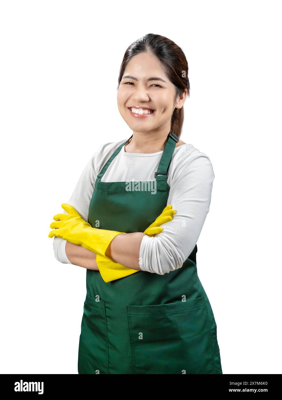 Asian housekeeper wear yellow rubber gloves and green apron arm crossed ...