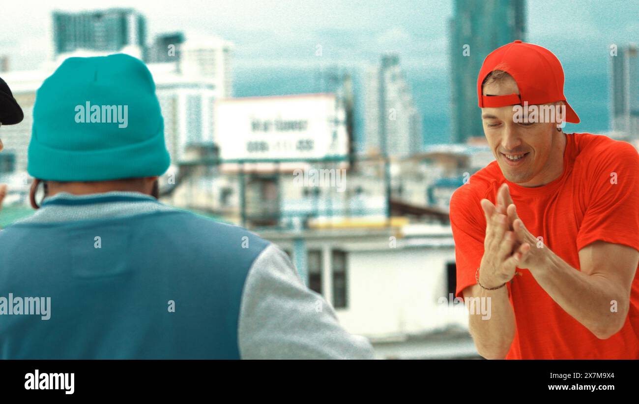 Professional caucasian rapper rap battle with partner at roof top ...