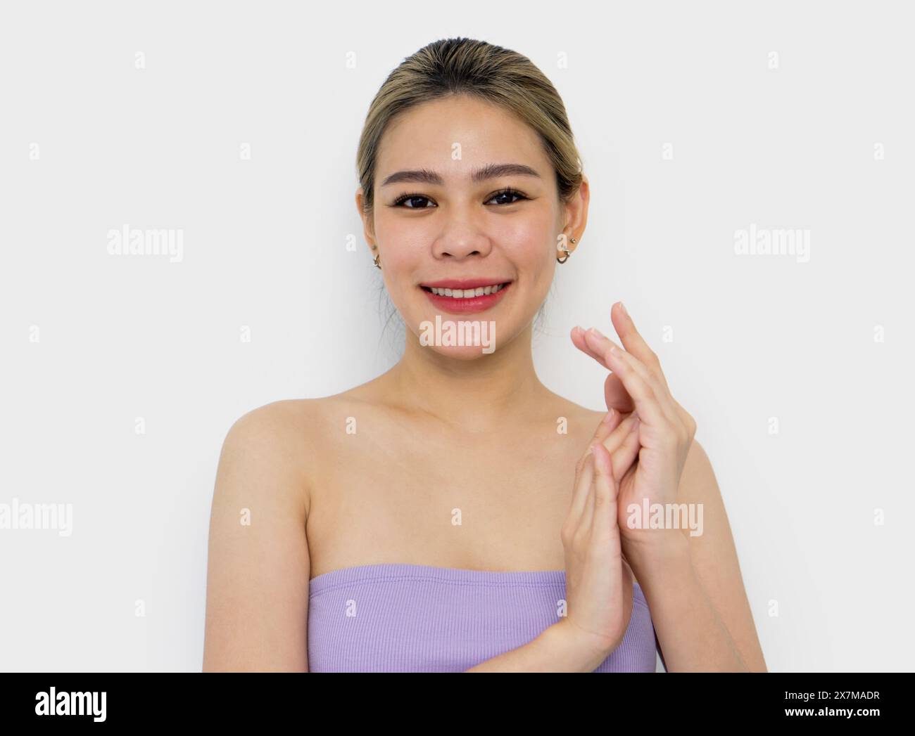 Expressive Emotions: A woman, dressed in a vibrant purple top, strikes ...