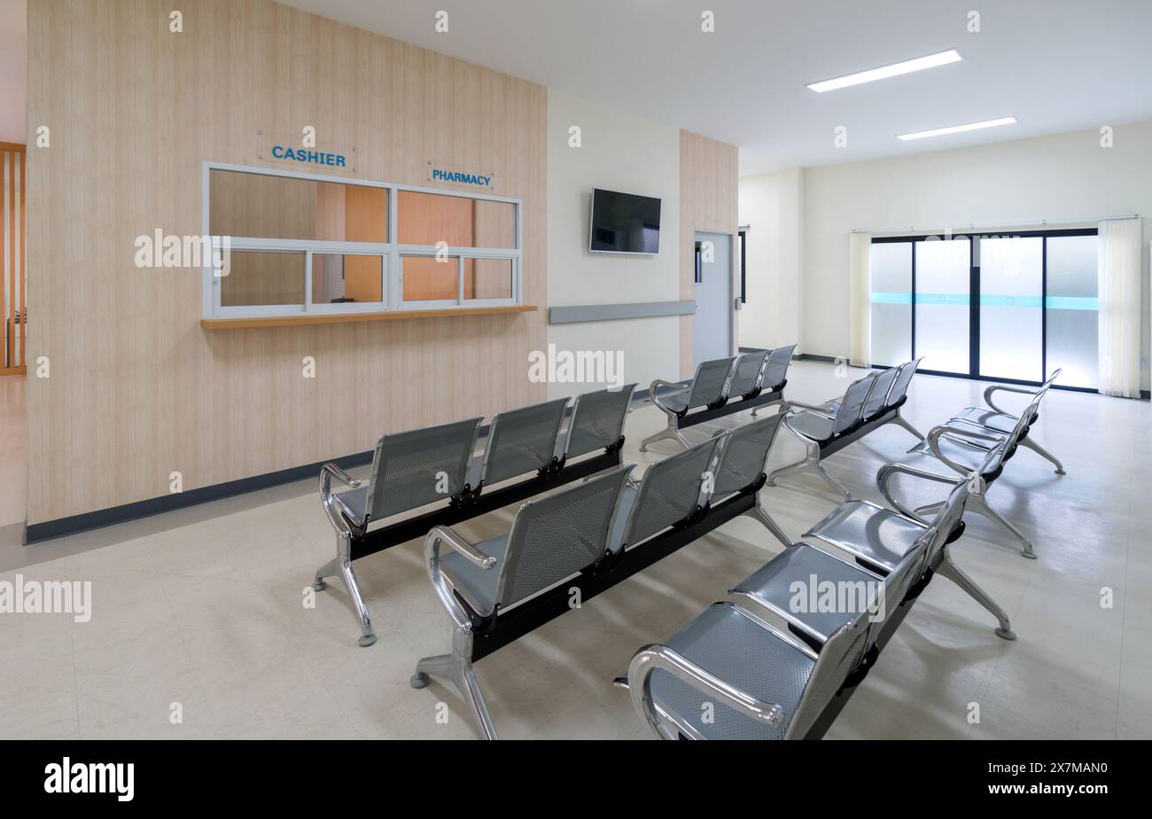 An empty waiting area with chairs, a cashier sign, and a pharmacy ...