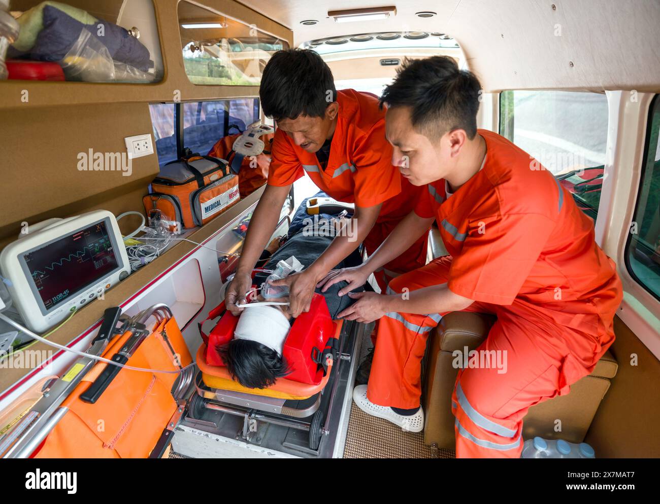 A person is wearing an oxygen mask, getting help from paramedic in ...