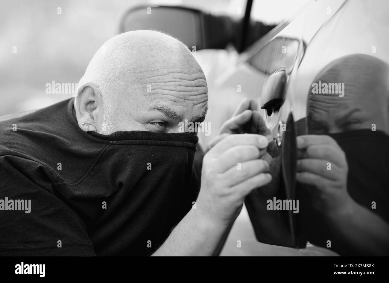 Close up car thief stealing car. Unlocked car, man trying to break into ...