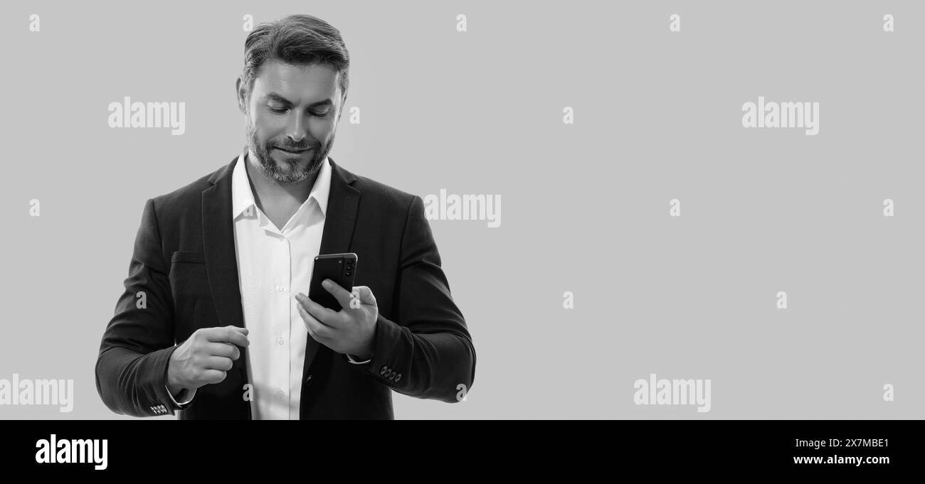 Portrait of handsome man in suit using smartphone, chatting, making ...