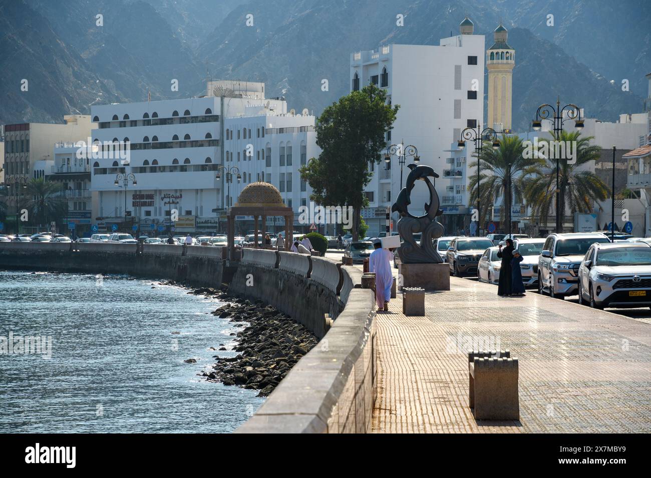 Muscat, Oman - January 2, 2024: Locals stroll along Muscat’s Corniche ...