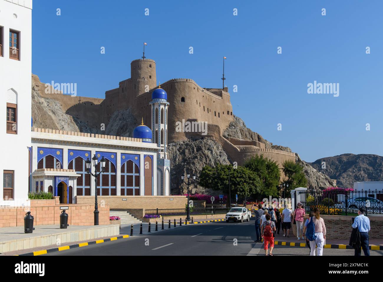 Muscat, Oman - January 2, 2024: Tourists walking near a majestic ...