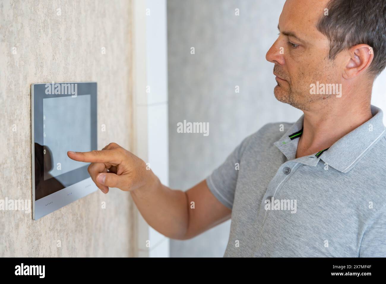Man using tablet panel application for control smart home living ...