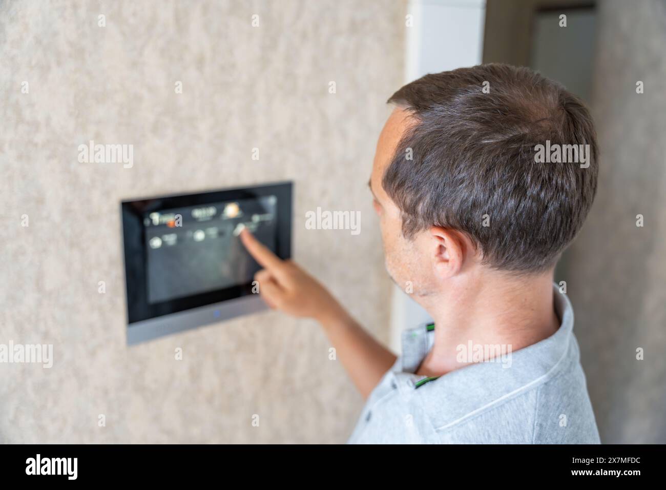 Man using tablet panel application for control smart home living ...