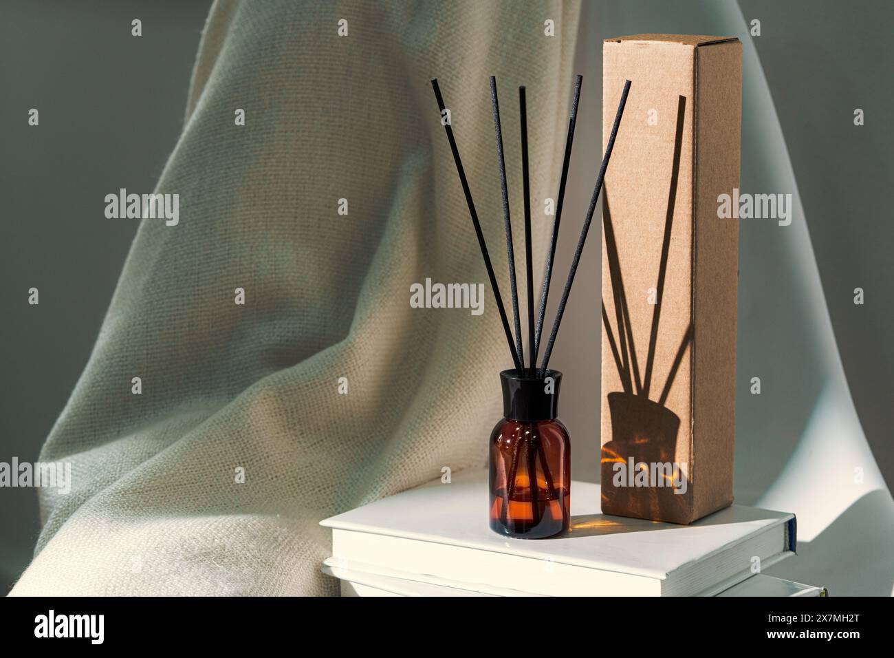 Liquid home perfume in glass diffuser with sticks on chair Stock Photo ...