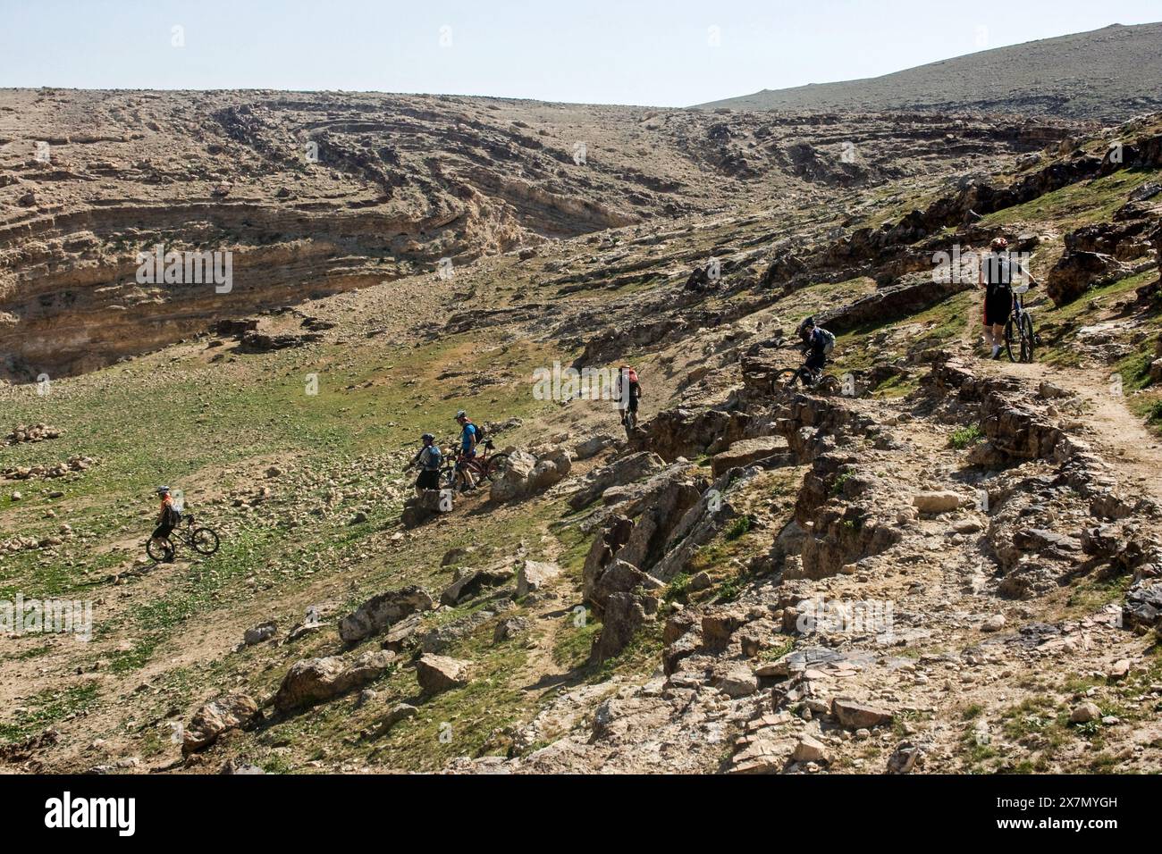 A group of cyclists on Mountain bikes touring in the Judean Desert ...