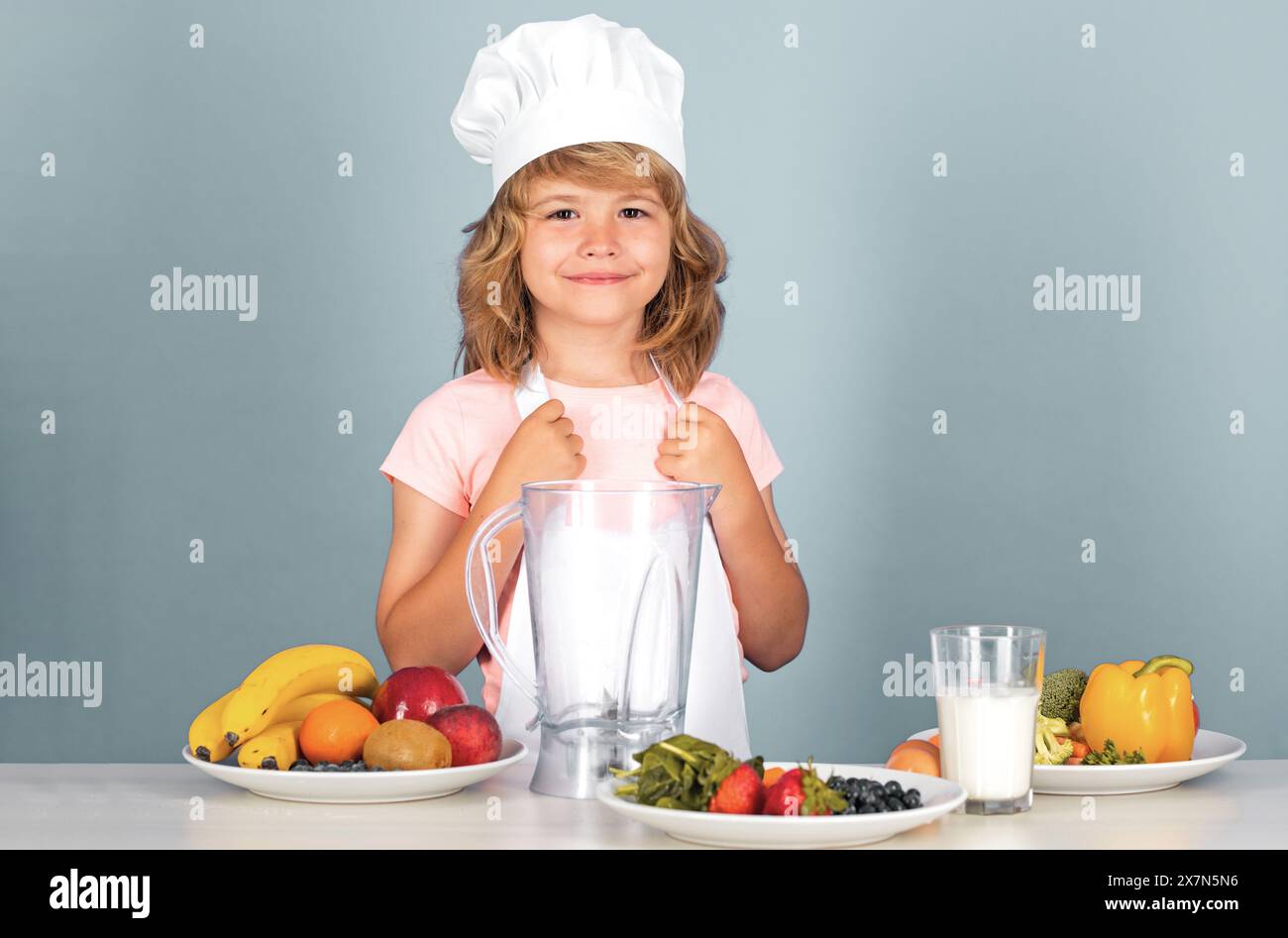 Child chef dressed cook baker apron and chef hat isolated on studio ...