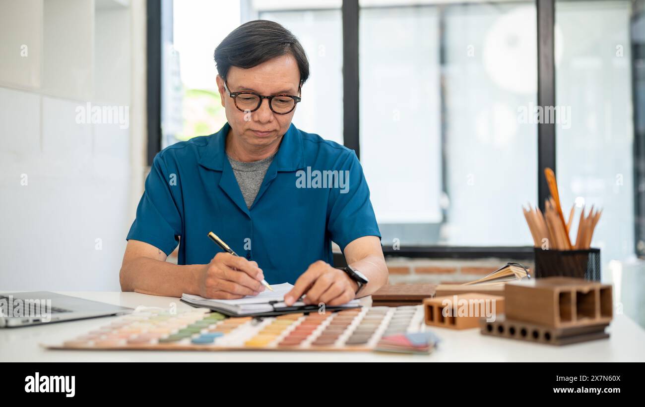 An experienced, professional senior Asian male interior designer or ...