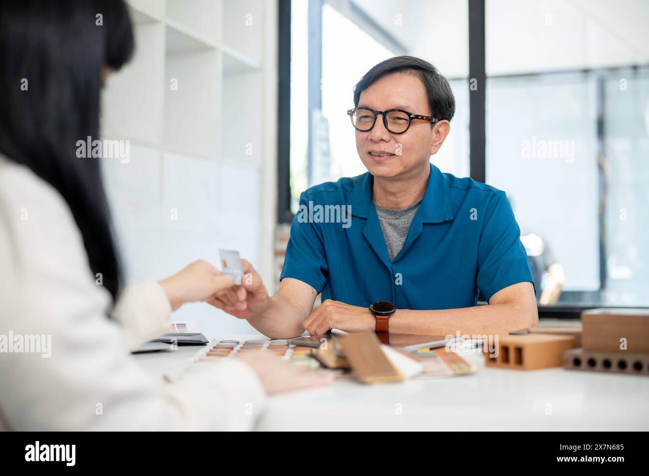 A positive, expert senior Asian male interior designer or contractor ...