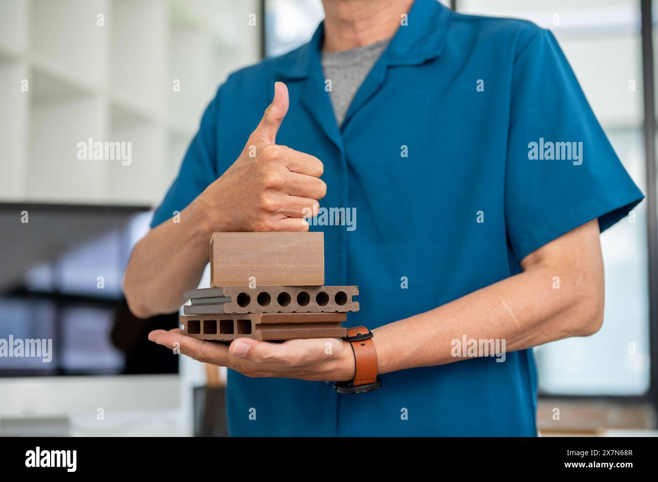 A close-up image of an architect or contractor holding brick material ...