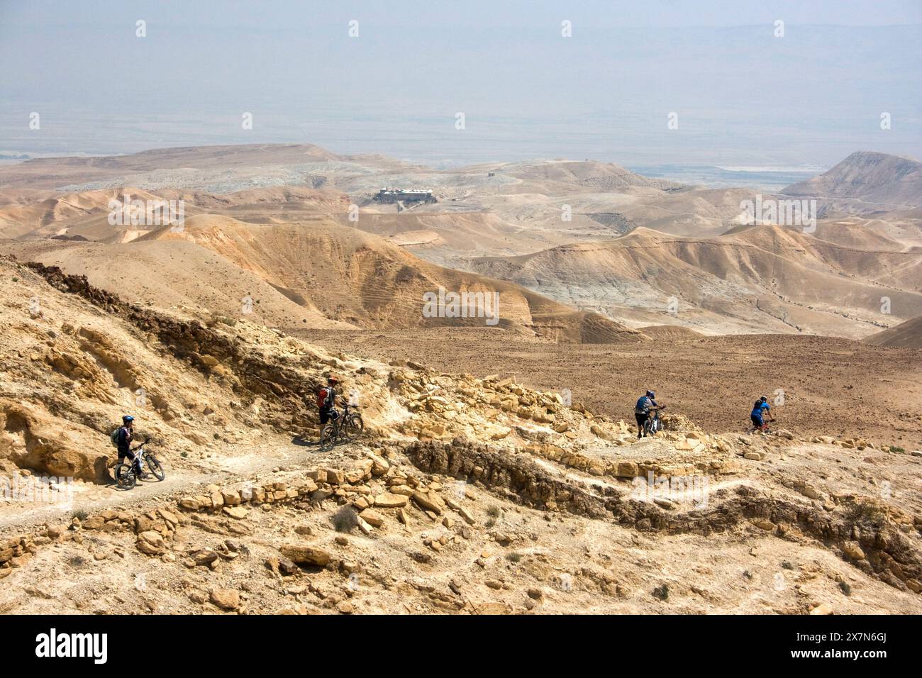 A group of cyclists on Mountain bikes touring in the Judean Desert ...