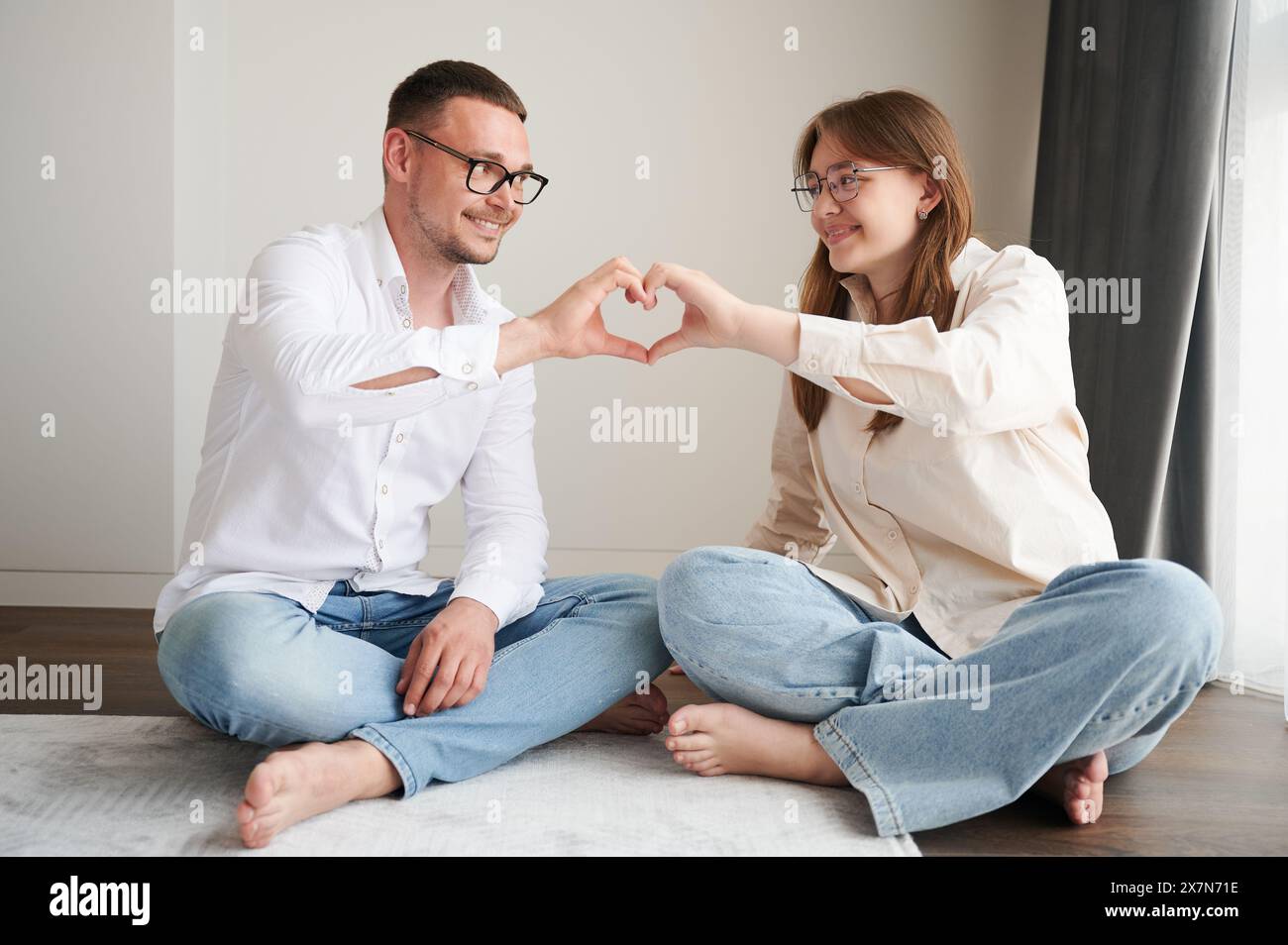 Young father and his daughter making heart symbol by hands. Lovely ...