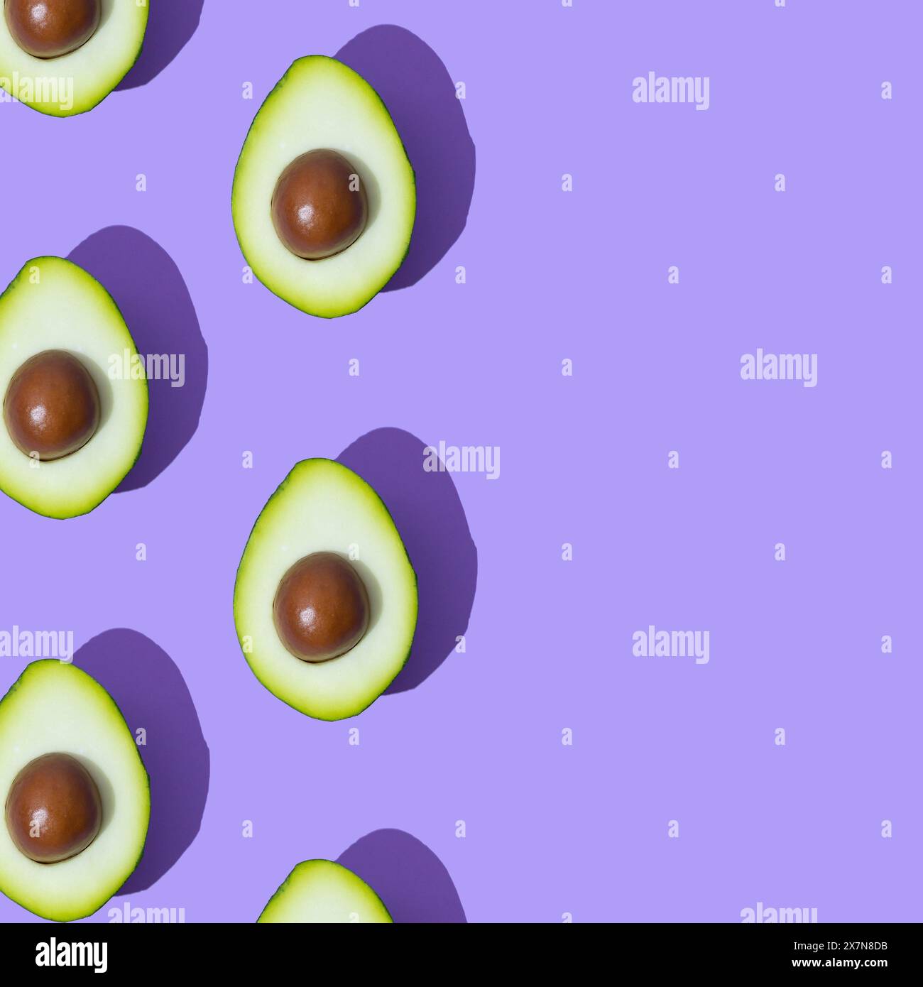 Trendy sunlight fresh avocado pattern on purple background with copy ...