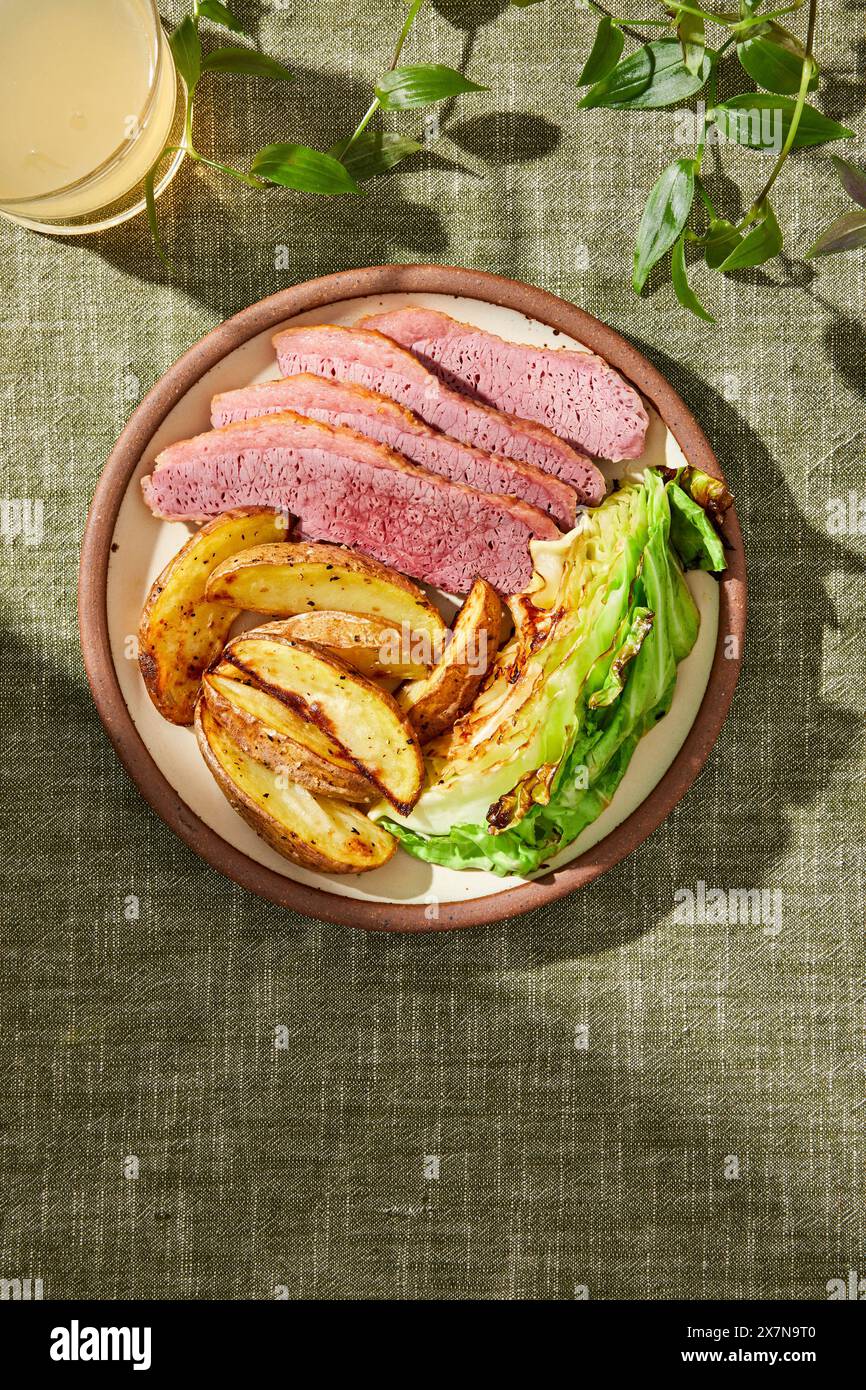 Corned Beef, Roasted Potatoes and Cabbage Meal on a green background ...